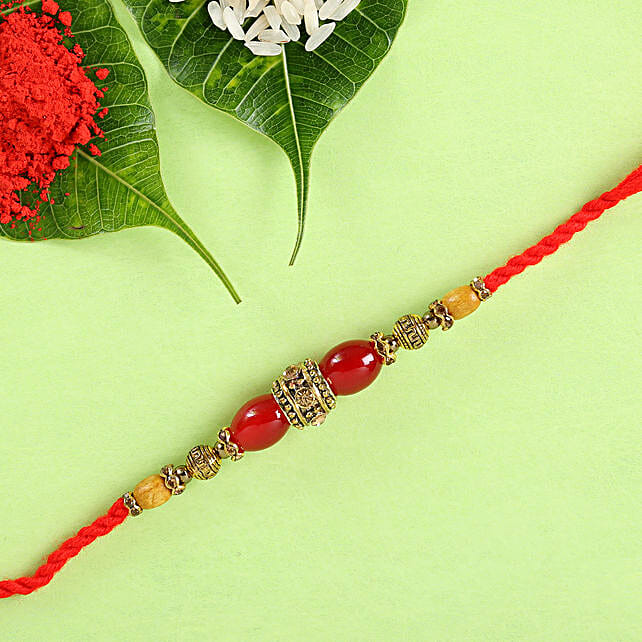 Buy/Send Red & Golden Pearl Rakhi Online- FNP