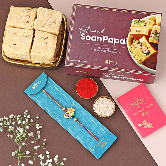 Buy/Send Sneh Devotional Ganesha Rakhi & Soan Papdi Box Online- FNP