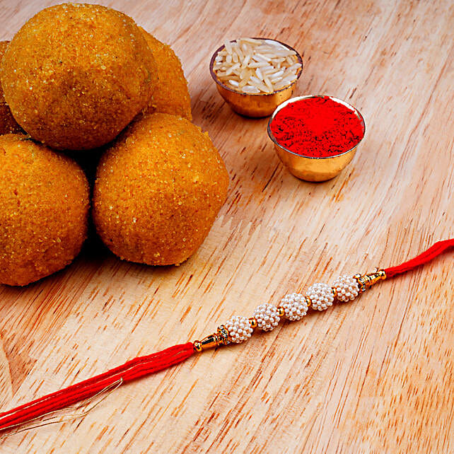 Fancy Golden Pearl Rakhi And Besan Laddoo singapore | Gift Fancy Golden ...